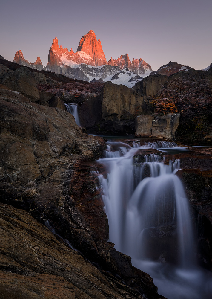 The Flow of Light - A waterfall gently flows under mount Fitz Roy ...
