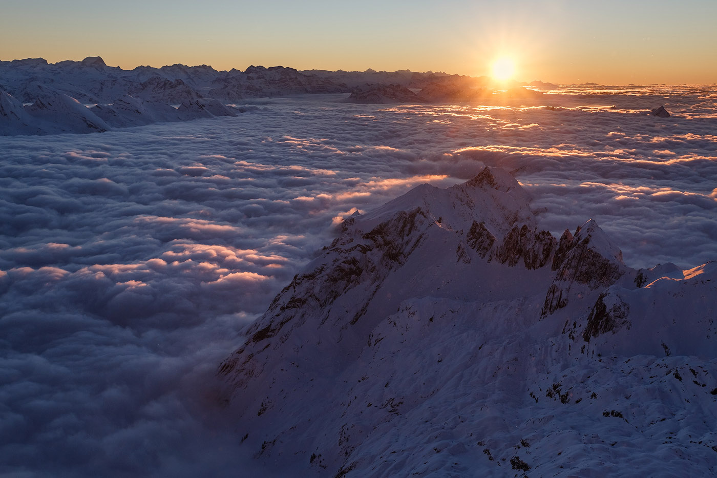 Alpine Ocean Sunset - The setting sun shines upon alpine peaks, rising ...