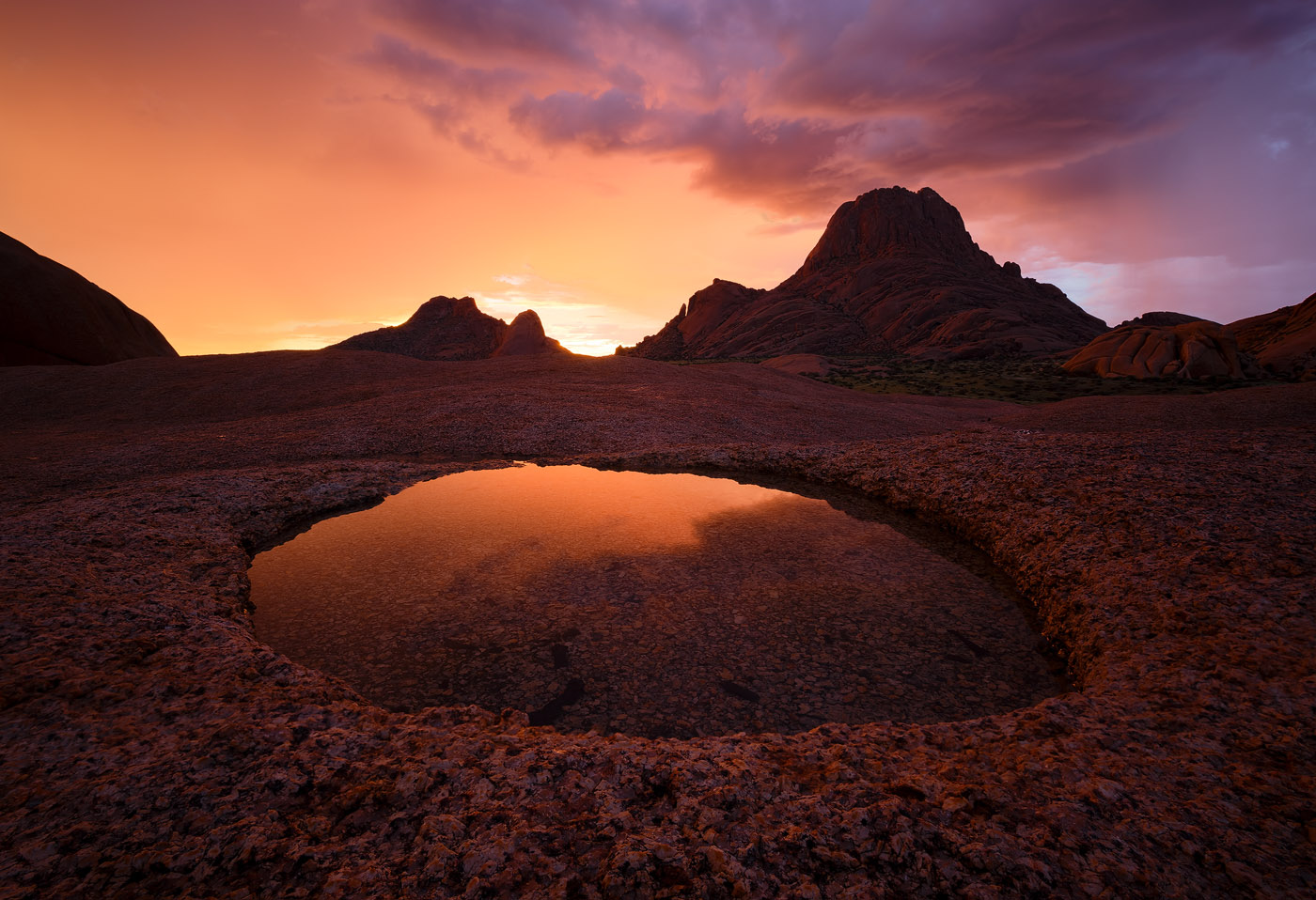 Foreboding Reds - Spitzkoppe Mountain under red storm clouds - Namibia